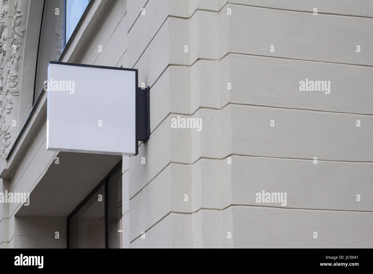 horizontal front view of empty white square signage on a building with ...