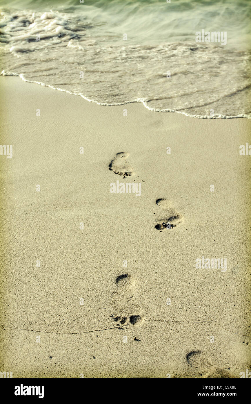 Footsteps in the sand on the beach Stock Photo - Alamy