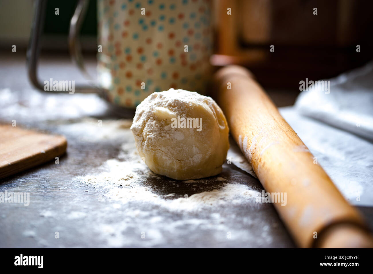 Kitchen scenery: dough, rolling stick covered by flour dust Stock Photo ...