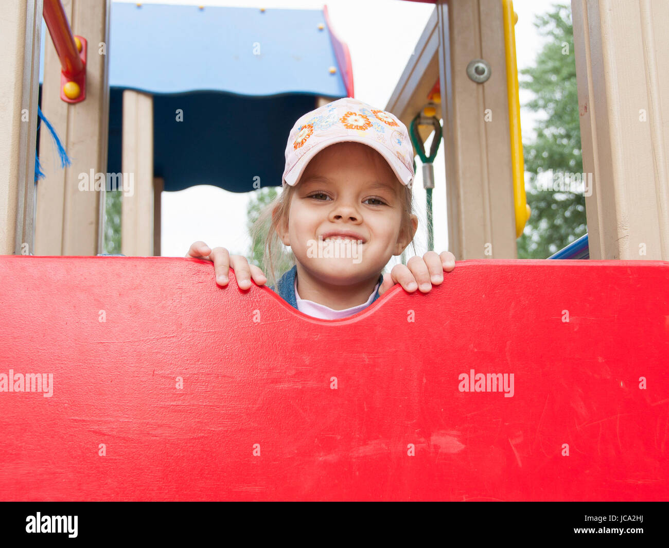 A girl peeks out from the top of the shield, while on the Playground ...