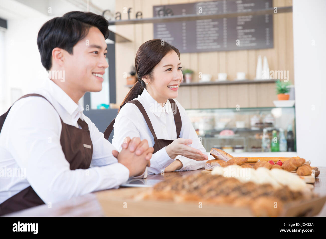 Smiling workers at bakery Stock Photo - Alamy