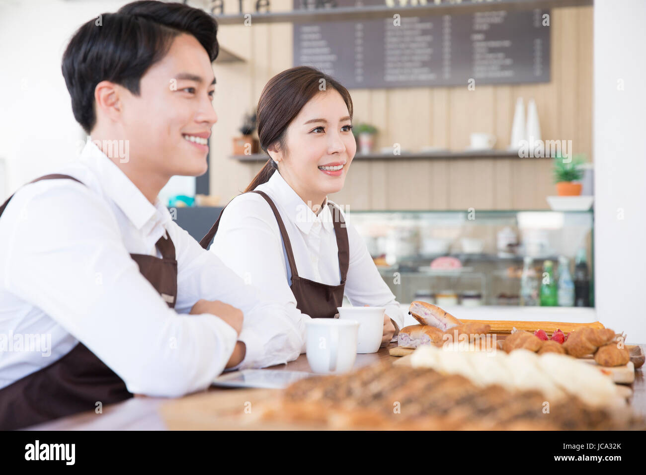 Smiling workers at bakery Stock Photo - Alamy