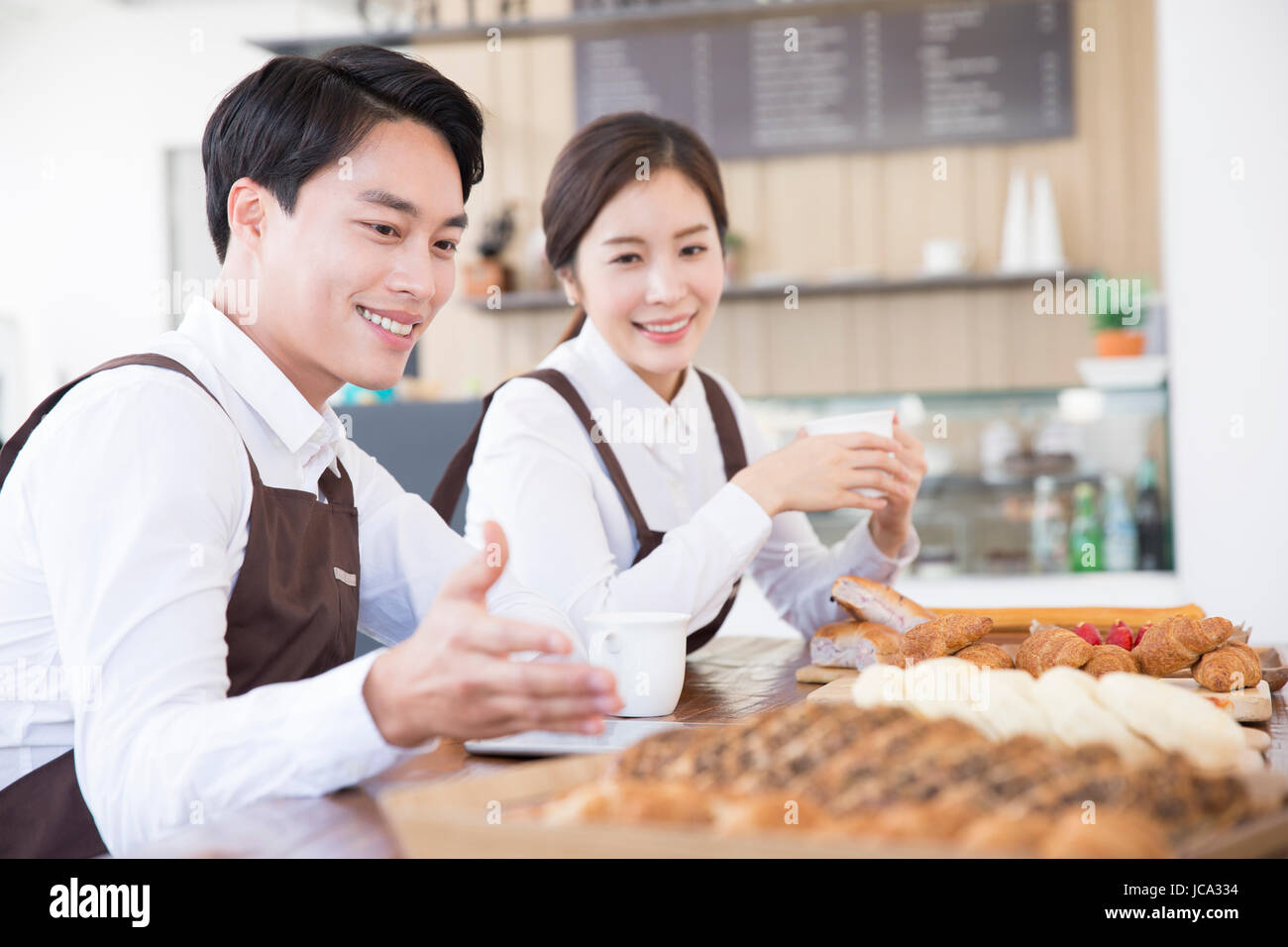 Smiling workers at bakery Stock Photo - Alamy