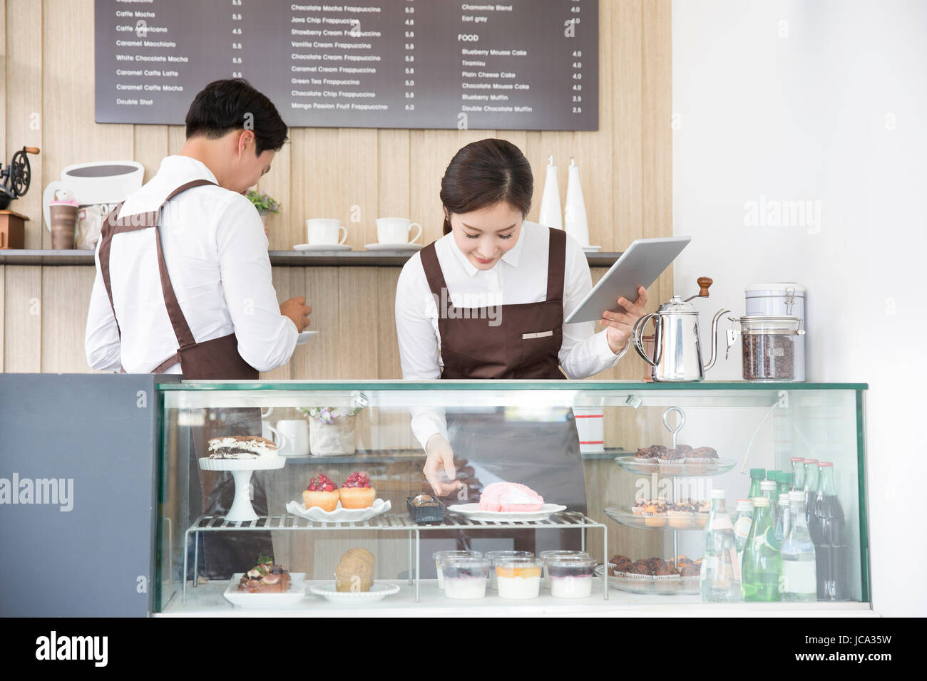 Smiling employees at bakery Stock Photo - Alamy