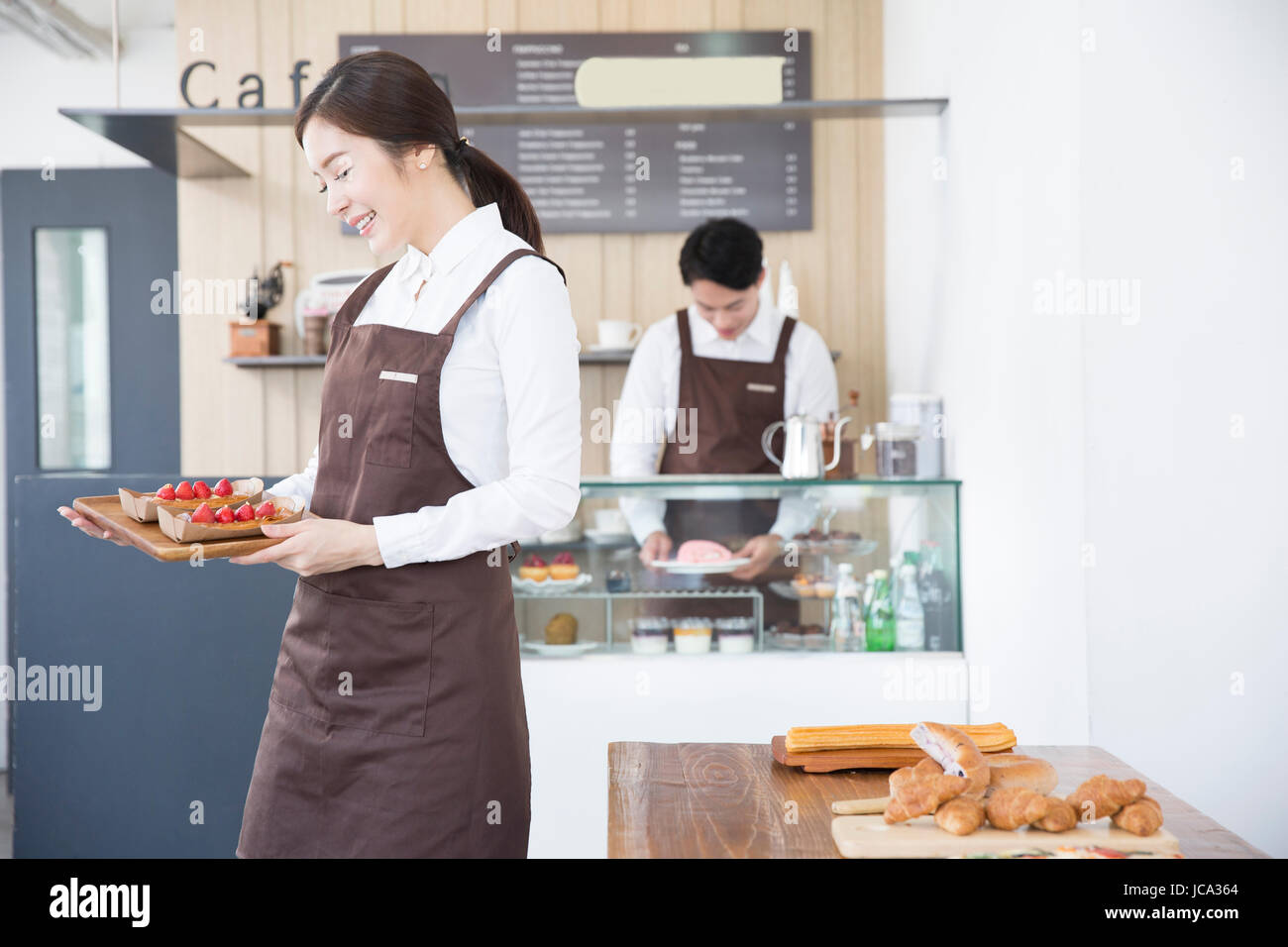 Smiling employees at bakery Stock Photo - Alamy