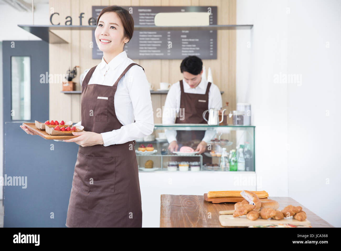 Smiling employees at bakery Stock Photo - Alamy