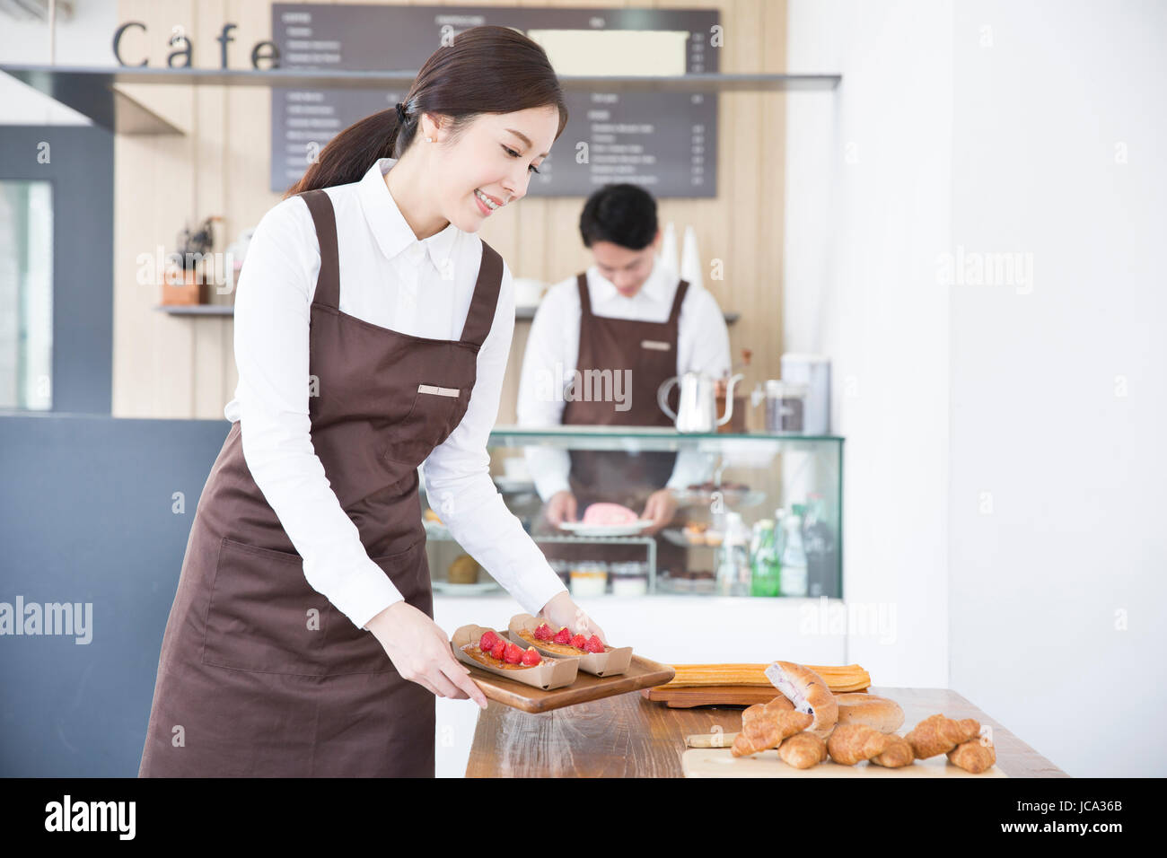 Smiling employees at bakery Stock Photo - Alamy