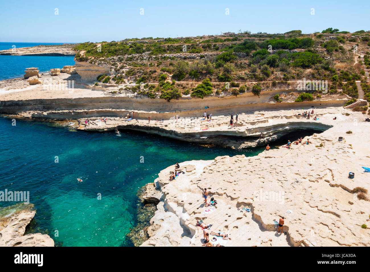 Marsaskala, Malta - May 31: People sunbathing and swimming on the Stock ...