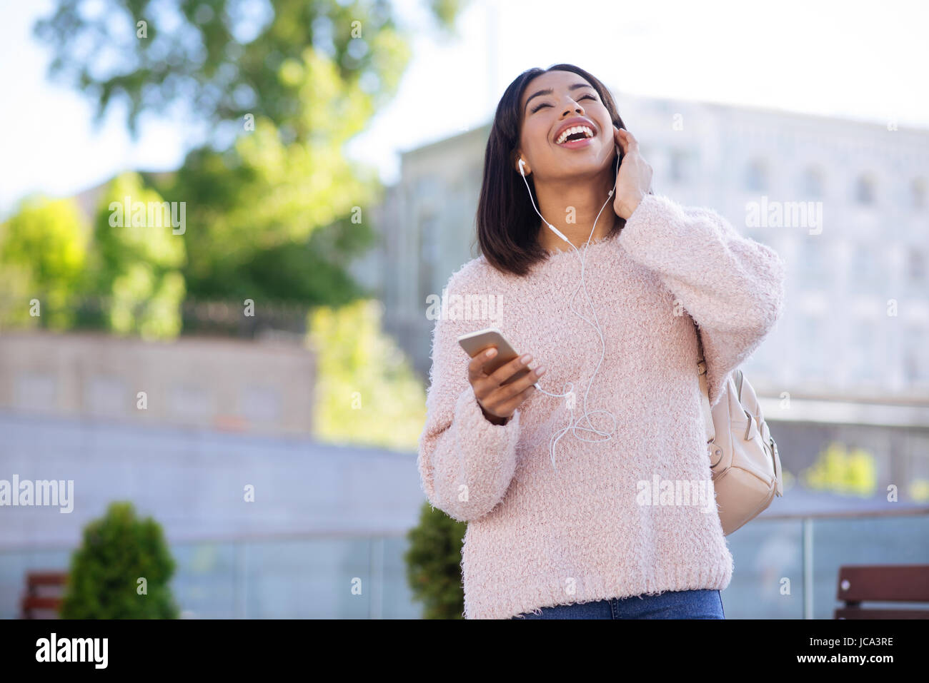 Captivated active woman enjoying the great sound Stock Photo - Alamy