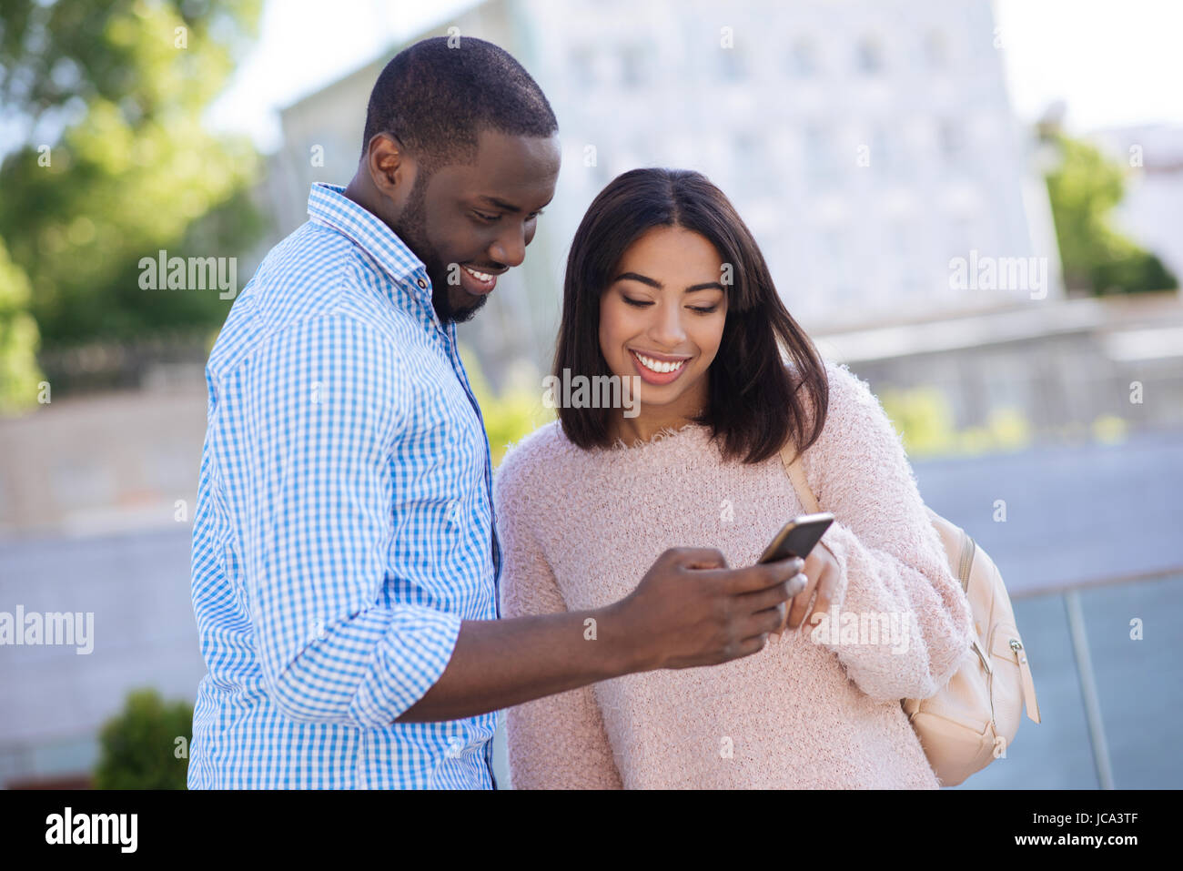 Cute young couple looking for a place to go Stock Photo - Alamy