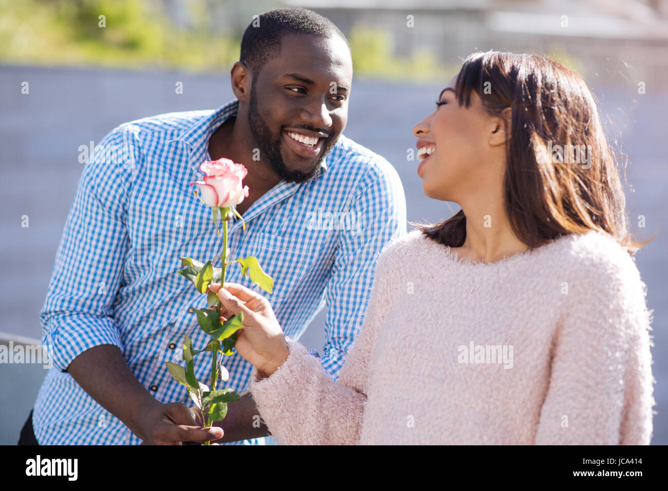 Inspiring handsome man making his lady happy Stock Photo - Alamy