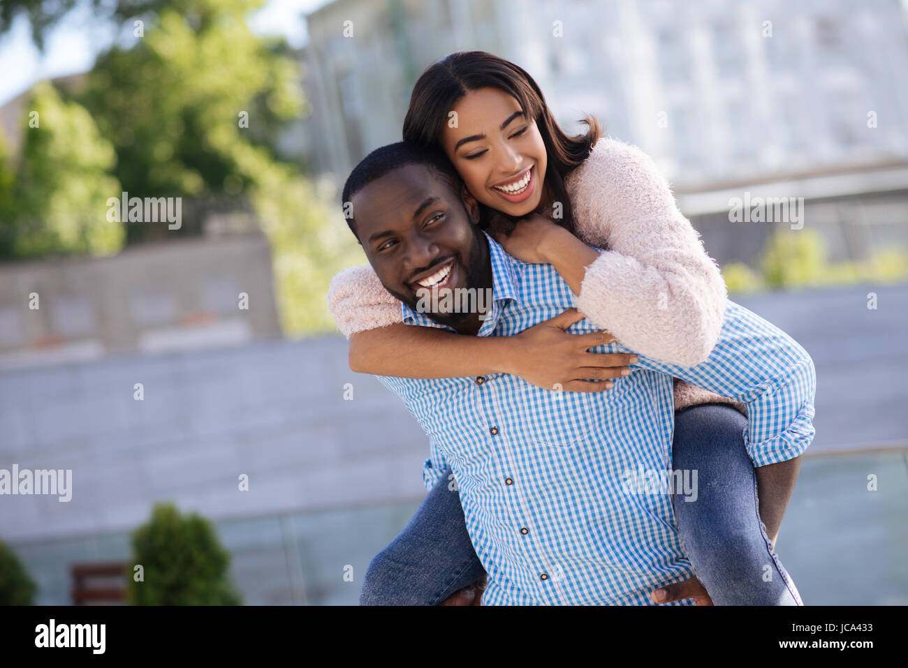 Energetic fun couple spending a bright day together Stock Photo - Alamy