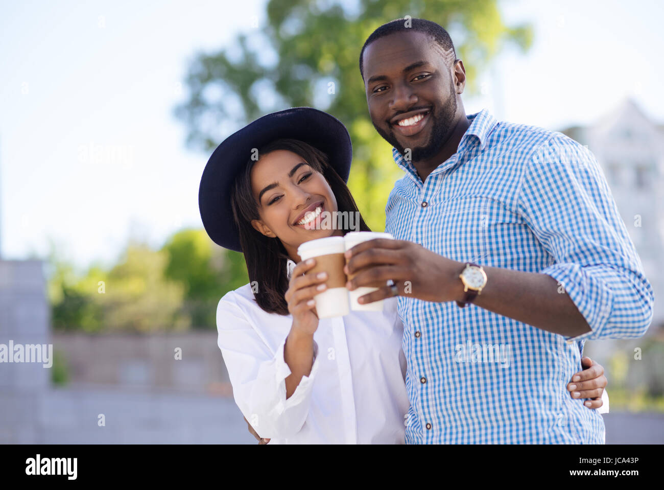 Modern active couple drinking coffee Stock Photo - Alamy