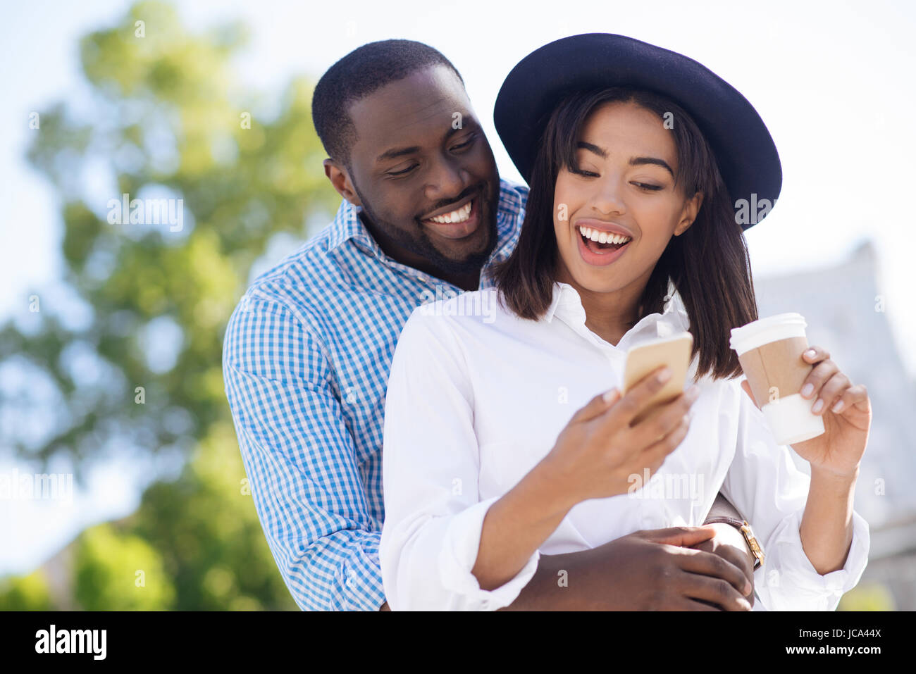 Fun smart lady showing her boyfriend something Stock Photo - Alamy