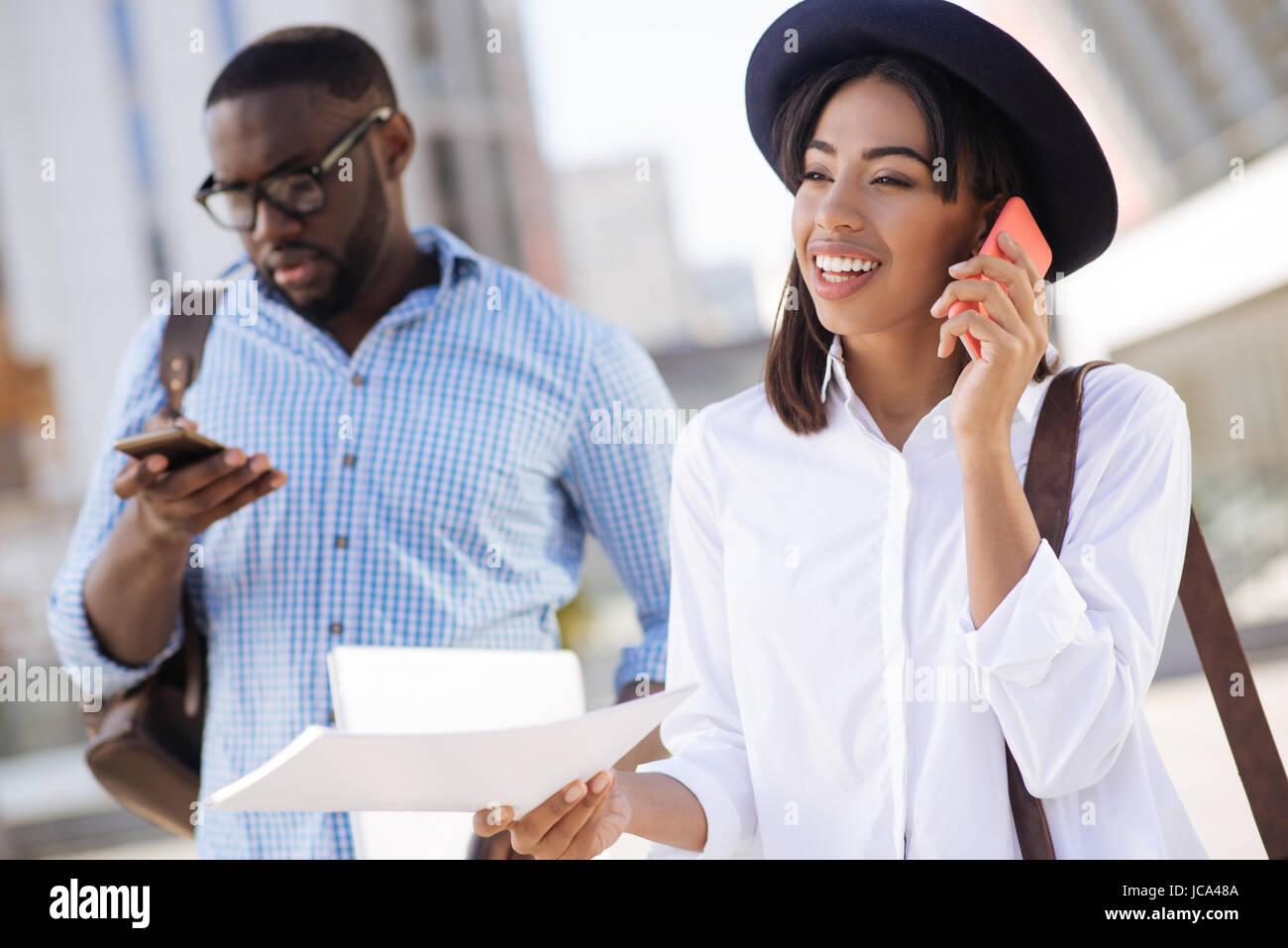 Enthusiastic industrious woman discussing her project on the phone ...