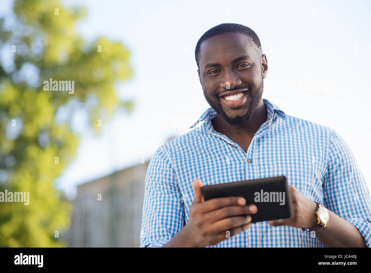 Positive modern guy checking his updates on social media Stock Photo ...
