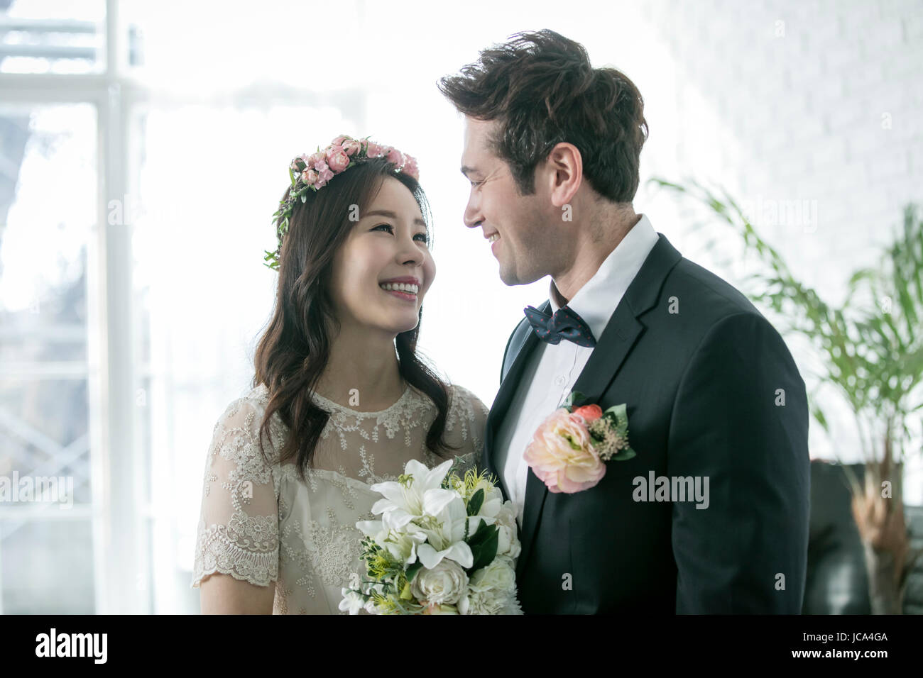 Portrait of smiling multicultural wedding couple Stock Photo - Alamy