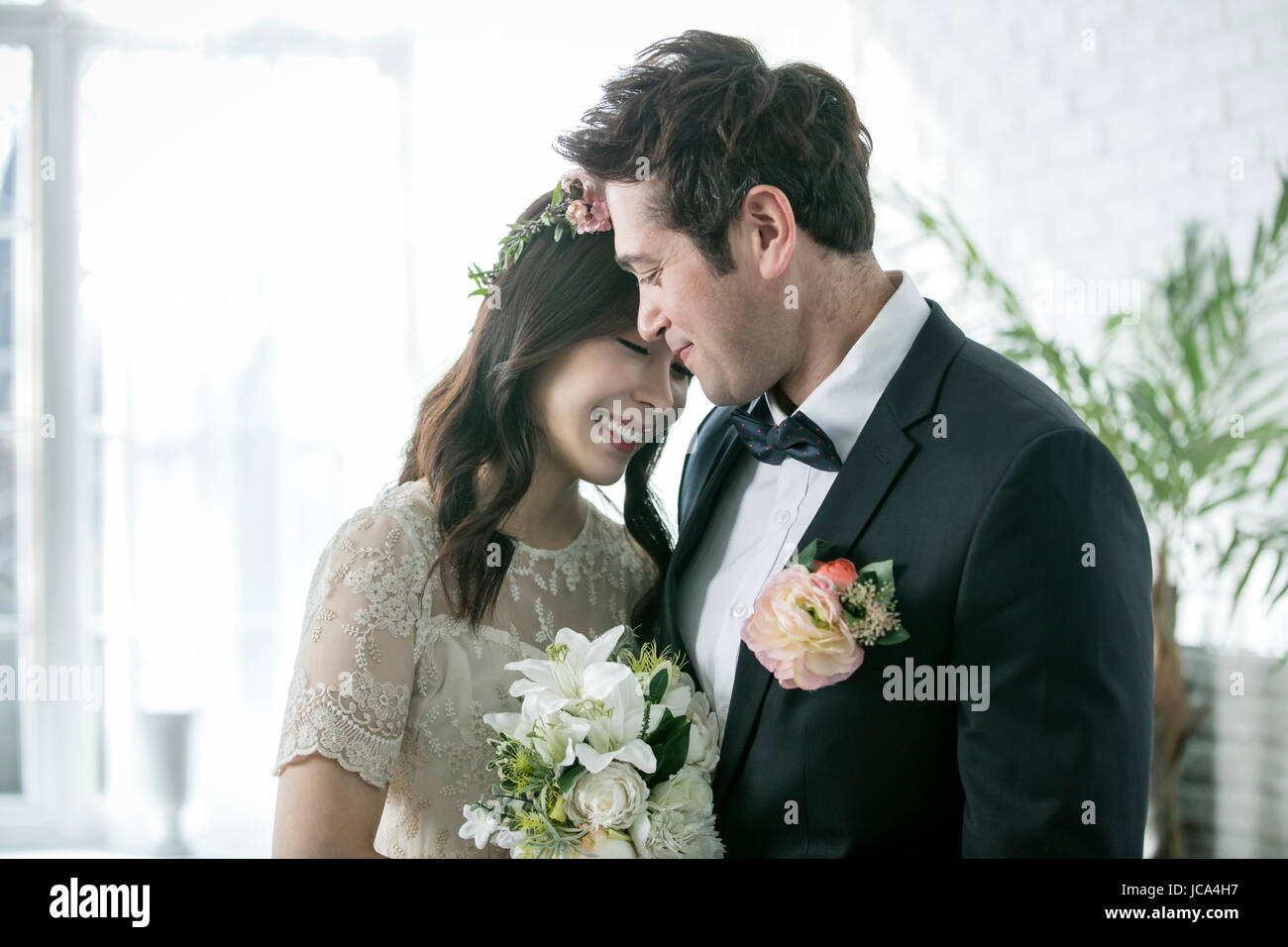 Portrait of multicultural wedding couple Stock Photo - Alamy