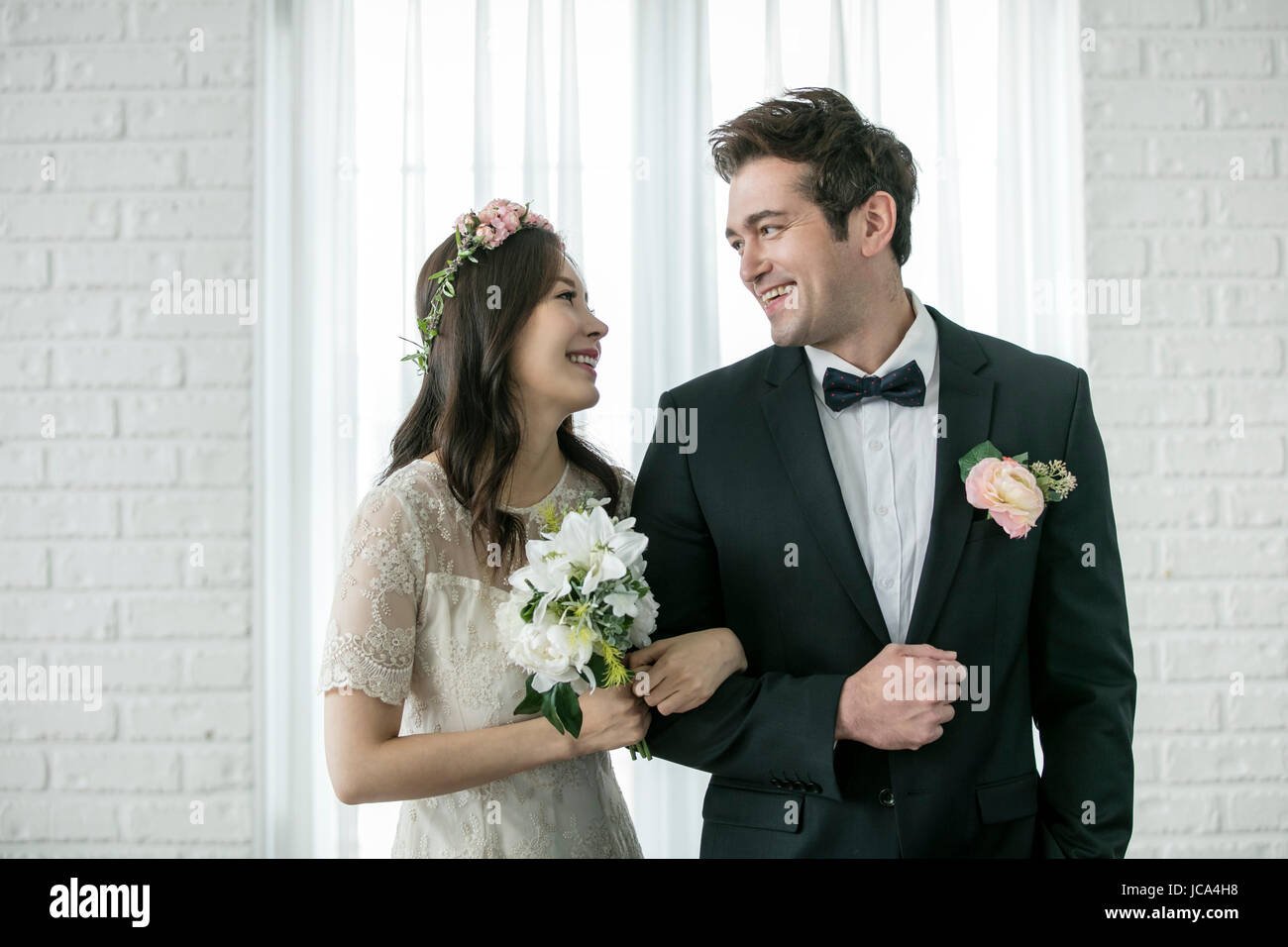 Portrait of smiling multicultural wedding couple Stock Photo - Alamy