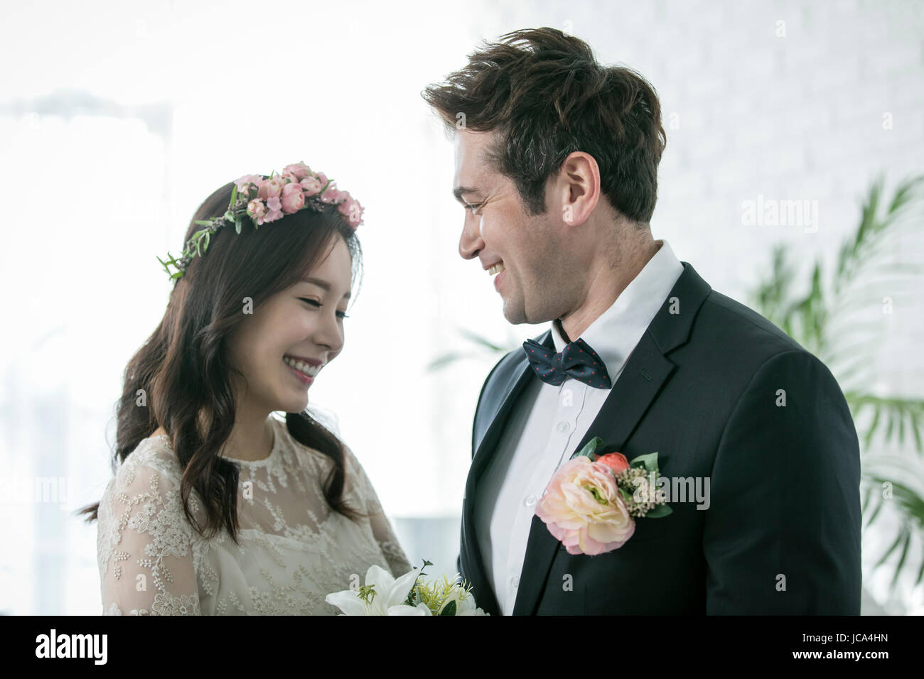 Portrait of smiling multicultural wedding couple Stock Photo - Alamy