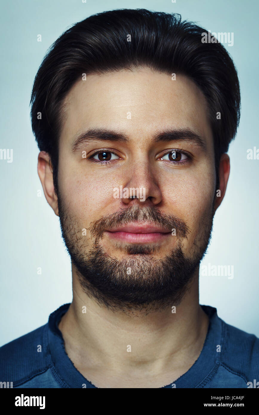 Young unshaven man with lush brunette hair front portrait close-up ...
