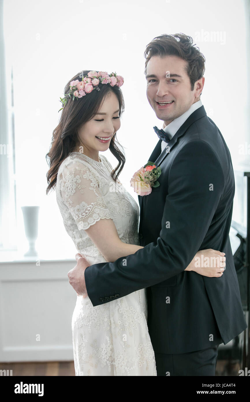 Smiling multicultural wedding couple Stock Photo - Alamy