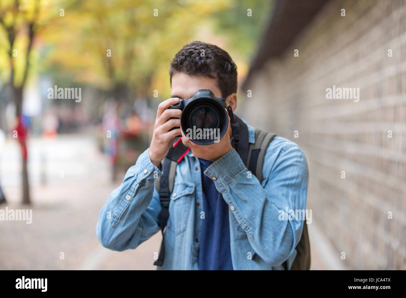 Portrait of smiling man with backpack hi-res stock photography and ...
