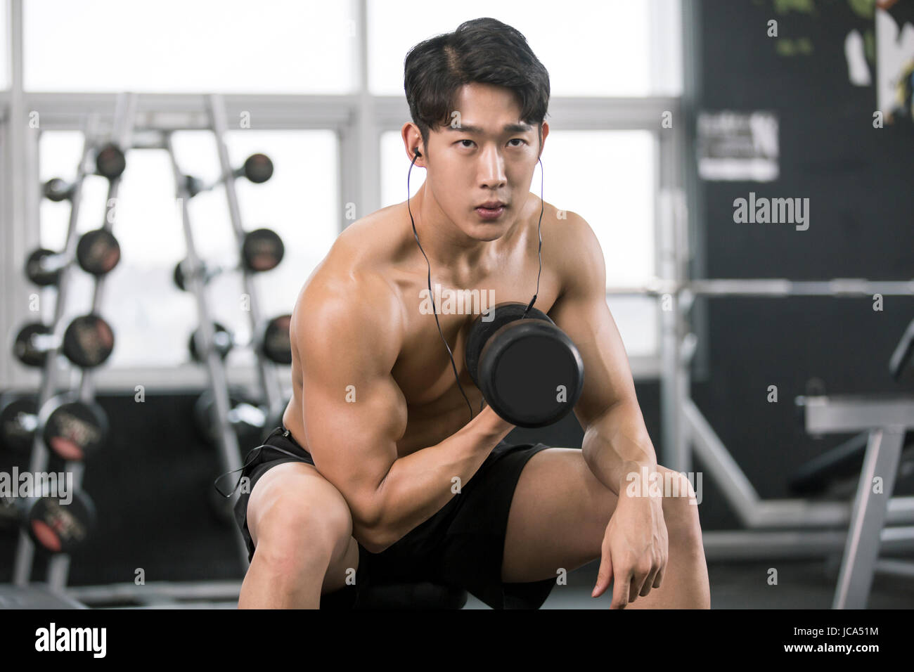 Muscular man exercising at gym Stock Photo - Alamy