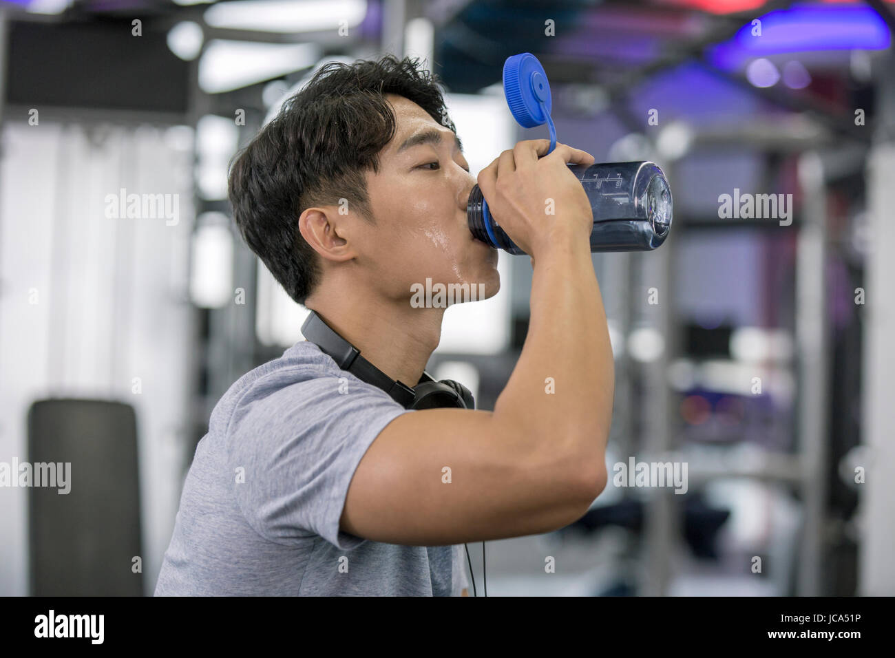 Portrait of man drinking water Stock Photo - Alamy