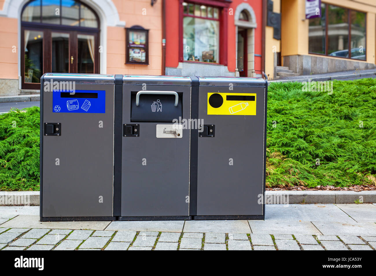 Three modern refuse bins in traditional europe city Stock Photo - Alamy