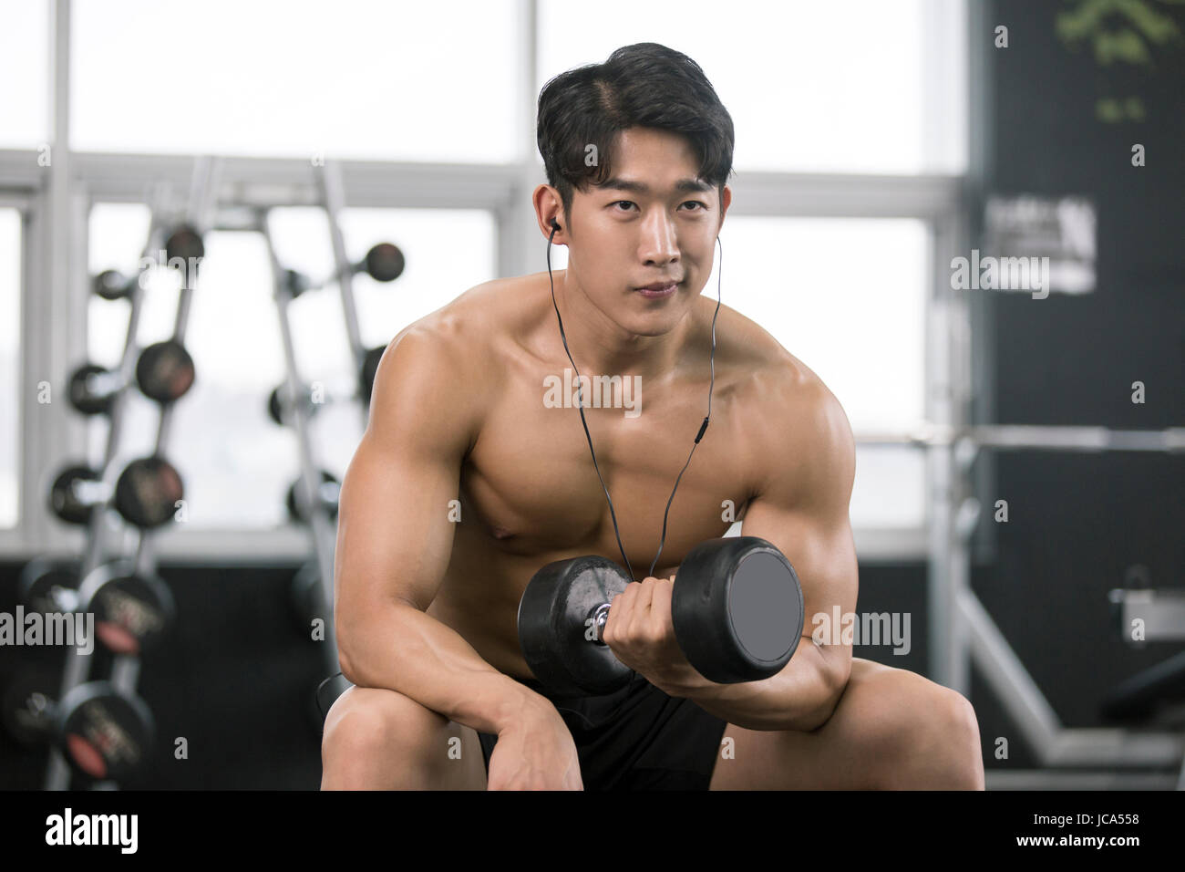 Young muscular man exercising Stock Photo - Alamy