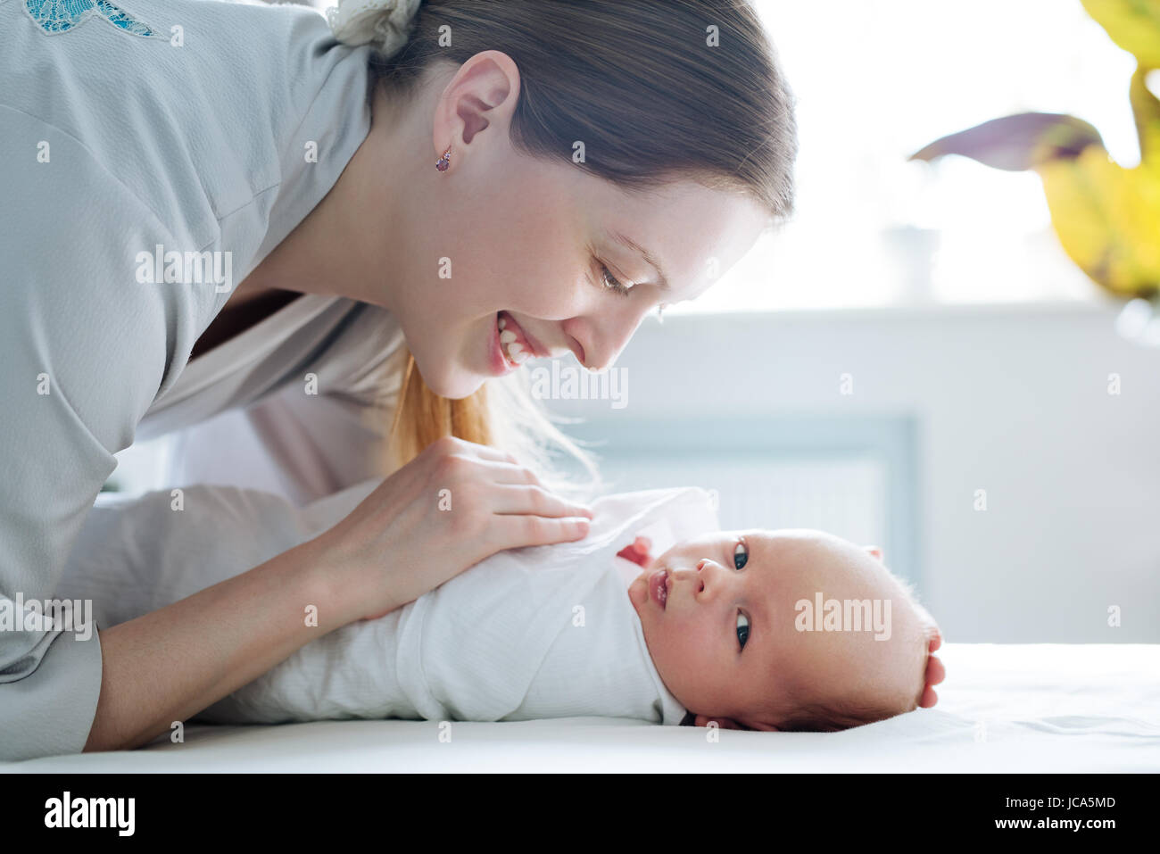 Mother with four month baby indoors portrait. Love and care concept ...