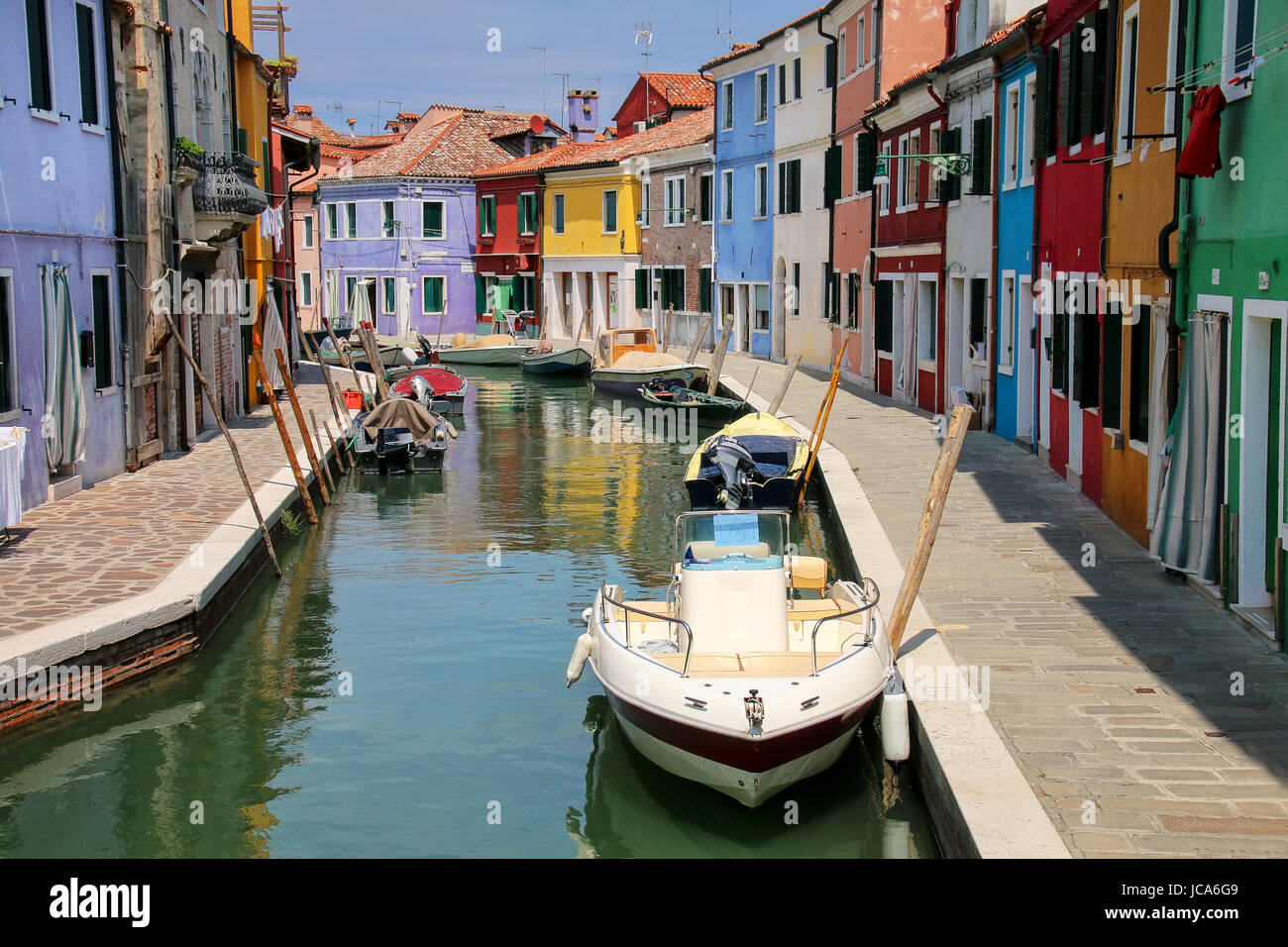 Colorful houses by canal in Burano, Venice, Italy. Burano is an island ...