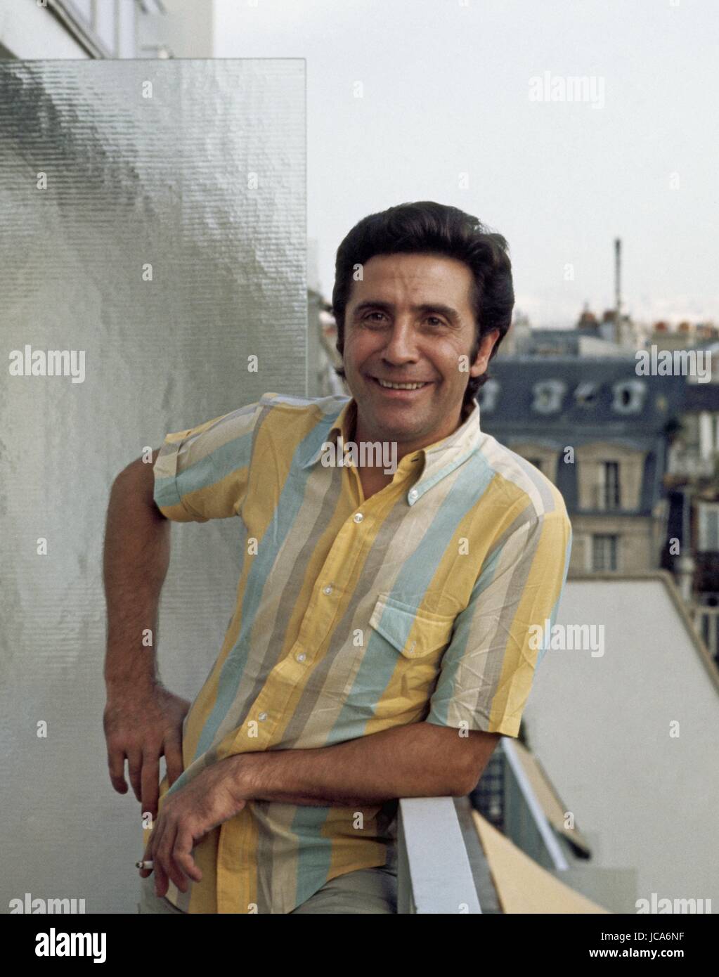 French singer Gilbert Bécaud on the terrace of his apartment located 6 ...