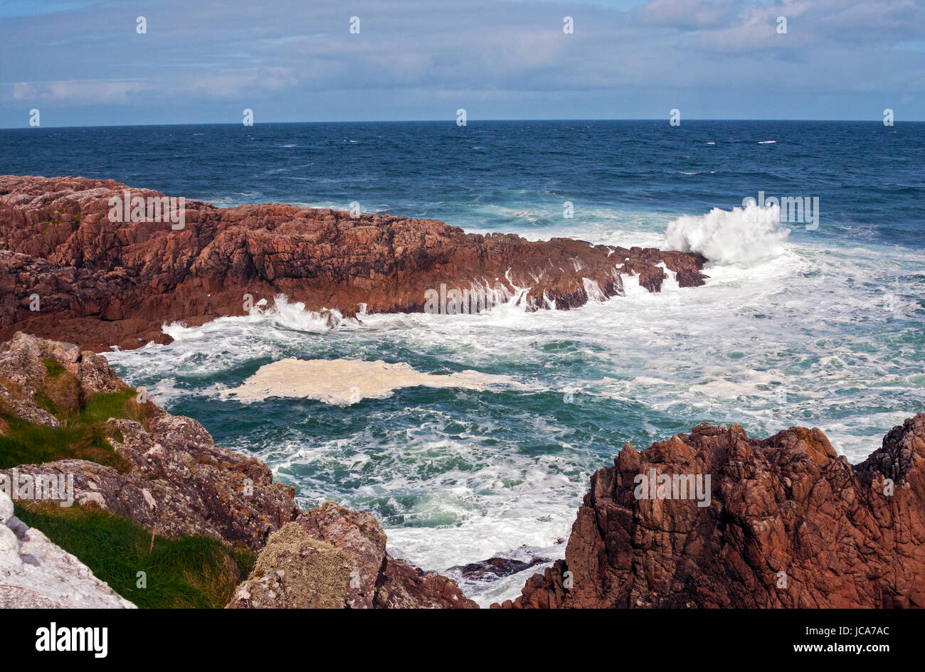 Waves crashing over rocks near Fanad Head Lighthouse, County Donegal ...