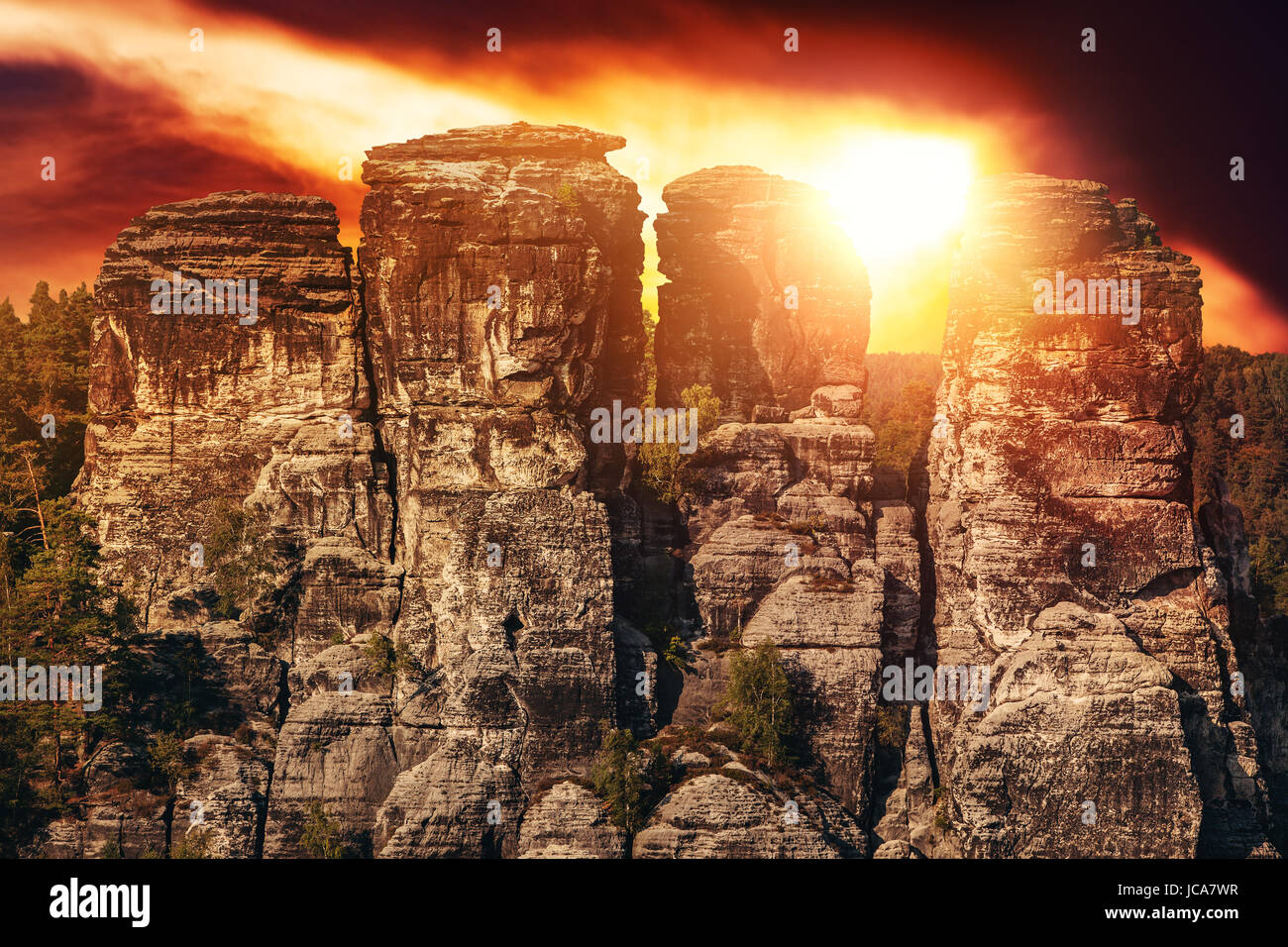 High rocks at sunset light dramatic colors Stock Photo - Alamy