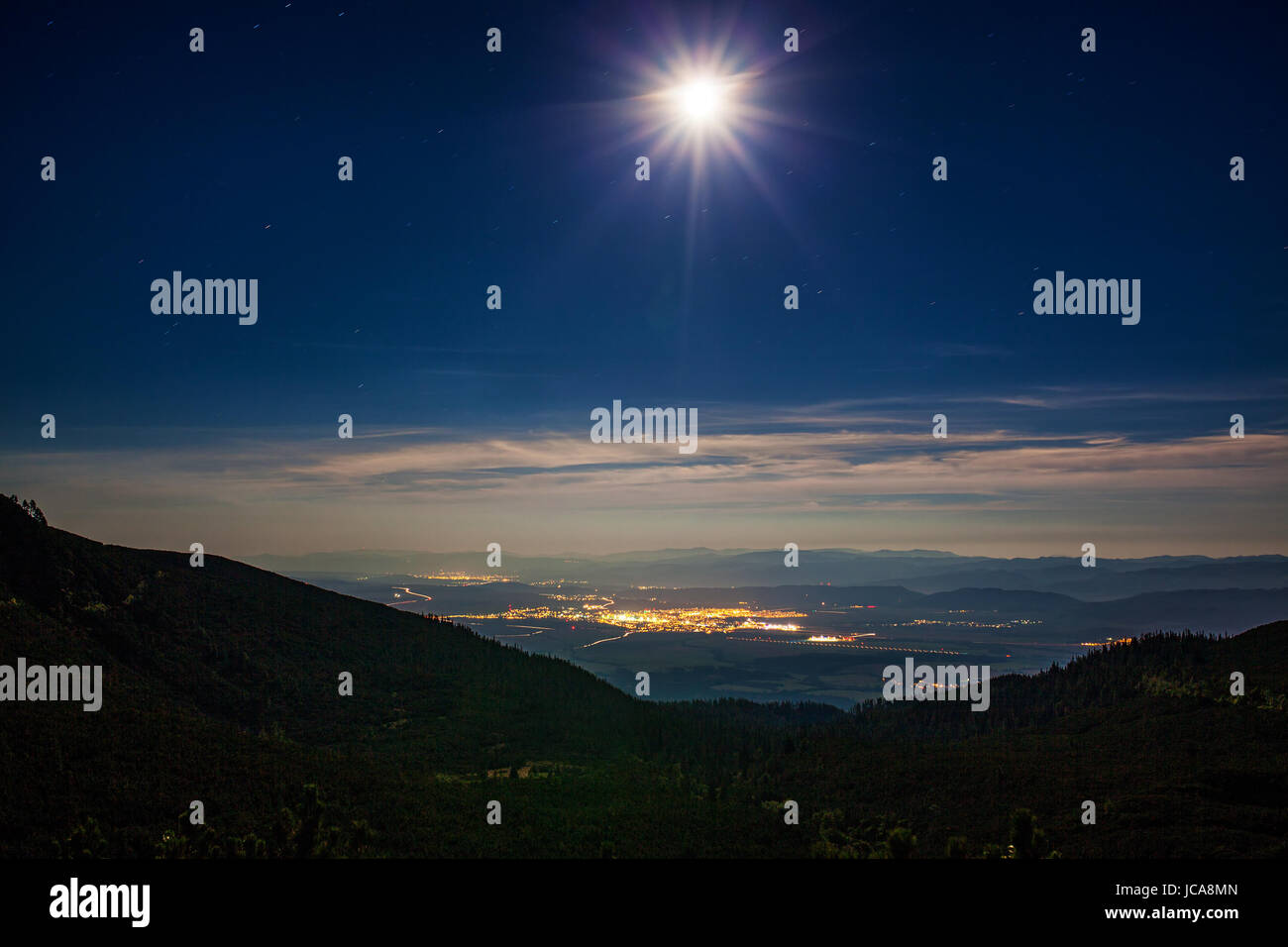 Night view with bright moon from mountains to lights and town Stock ...