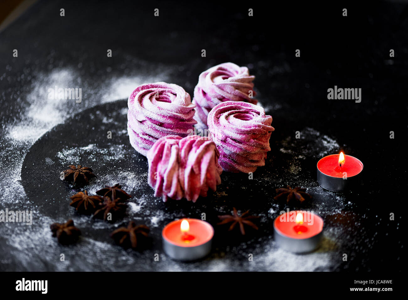 Many purple marshmallow on a dark surface. A contrasting picture. A ...