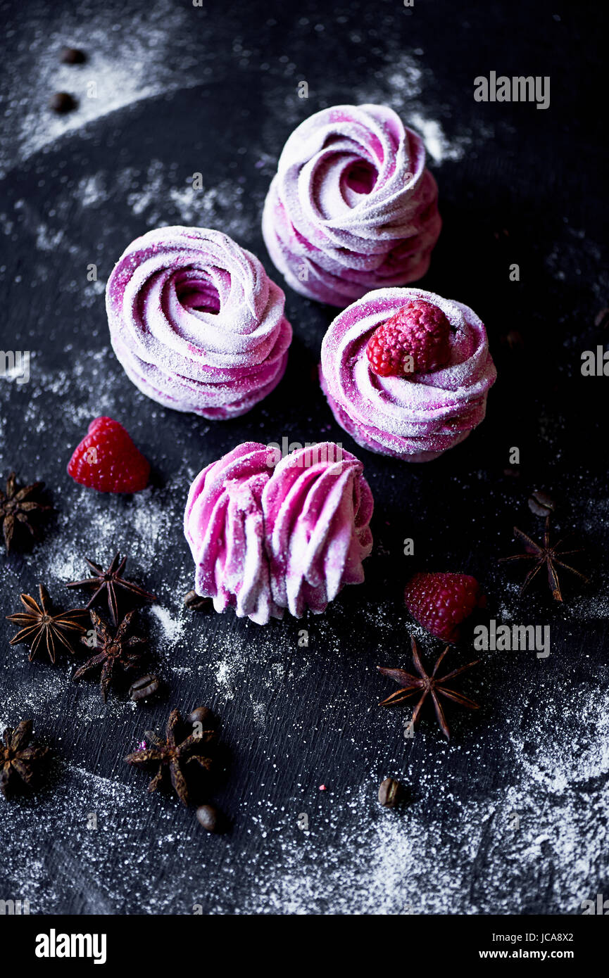 Many purple marshmallow on a dark surface. A contrasting picture. A ...