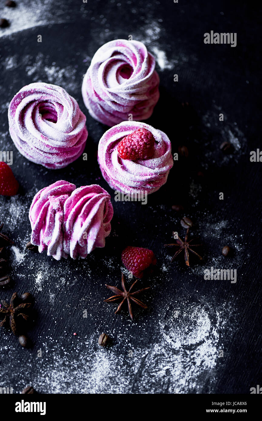 Many purple marshmallow on a dark surface. A contrasting picture. A ...