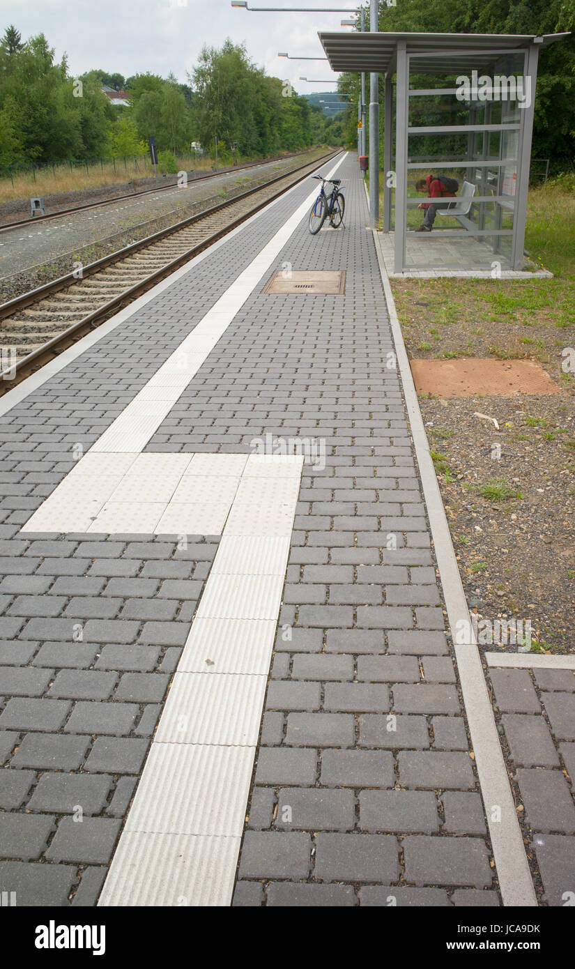 Block paving and indicator stripe on train station platform, with ...
