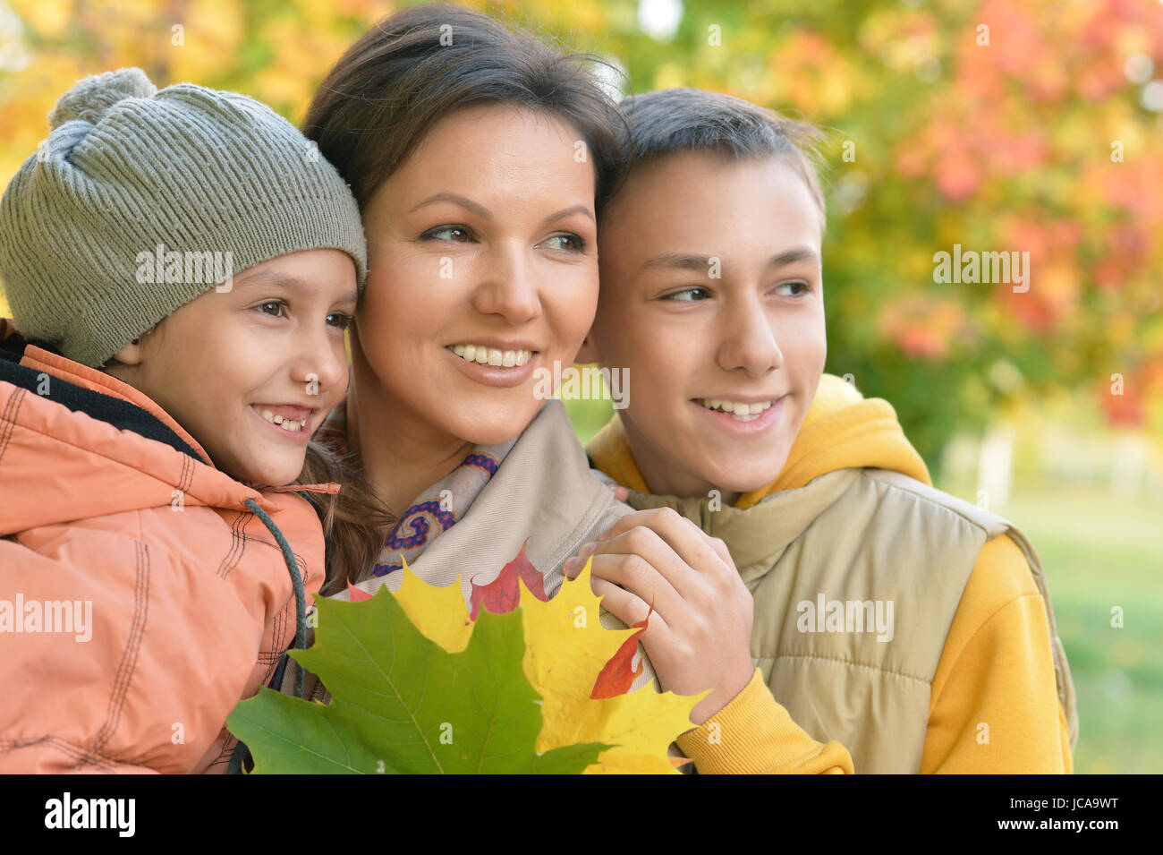 Family portrait of happy mother with children outdoors Stock Photo - Alamy