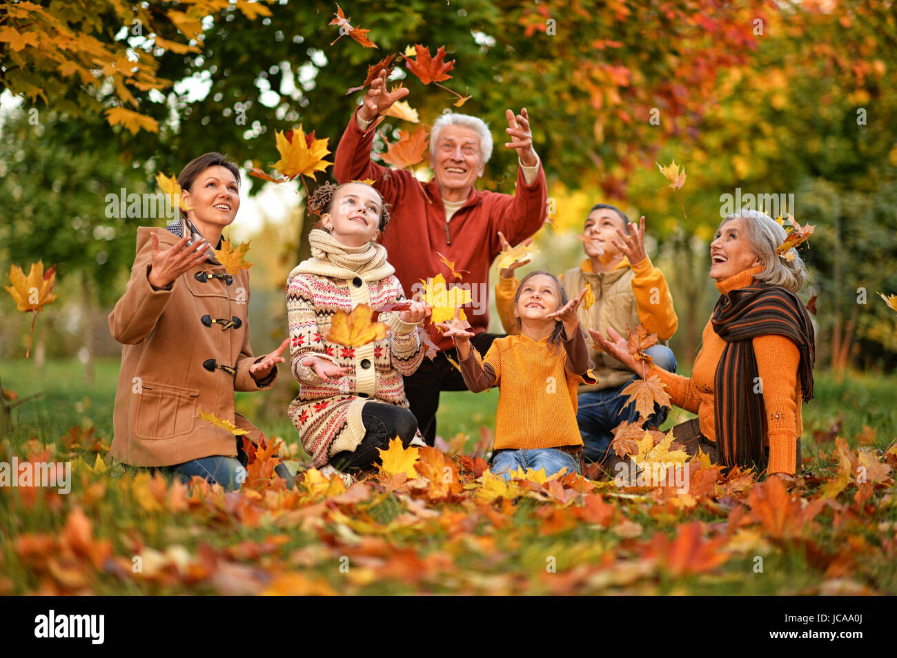 Big family having fun in autumnal park Stock Photo - Alamy
