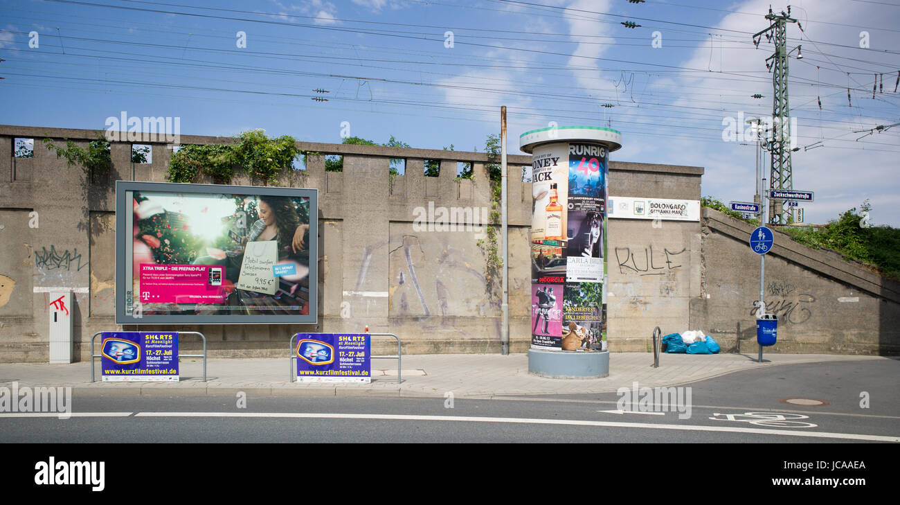 Advertising on pillar, traffic barriers, and billboard, Höchst ...