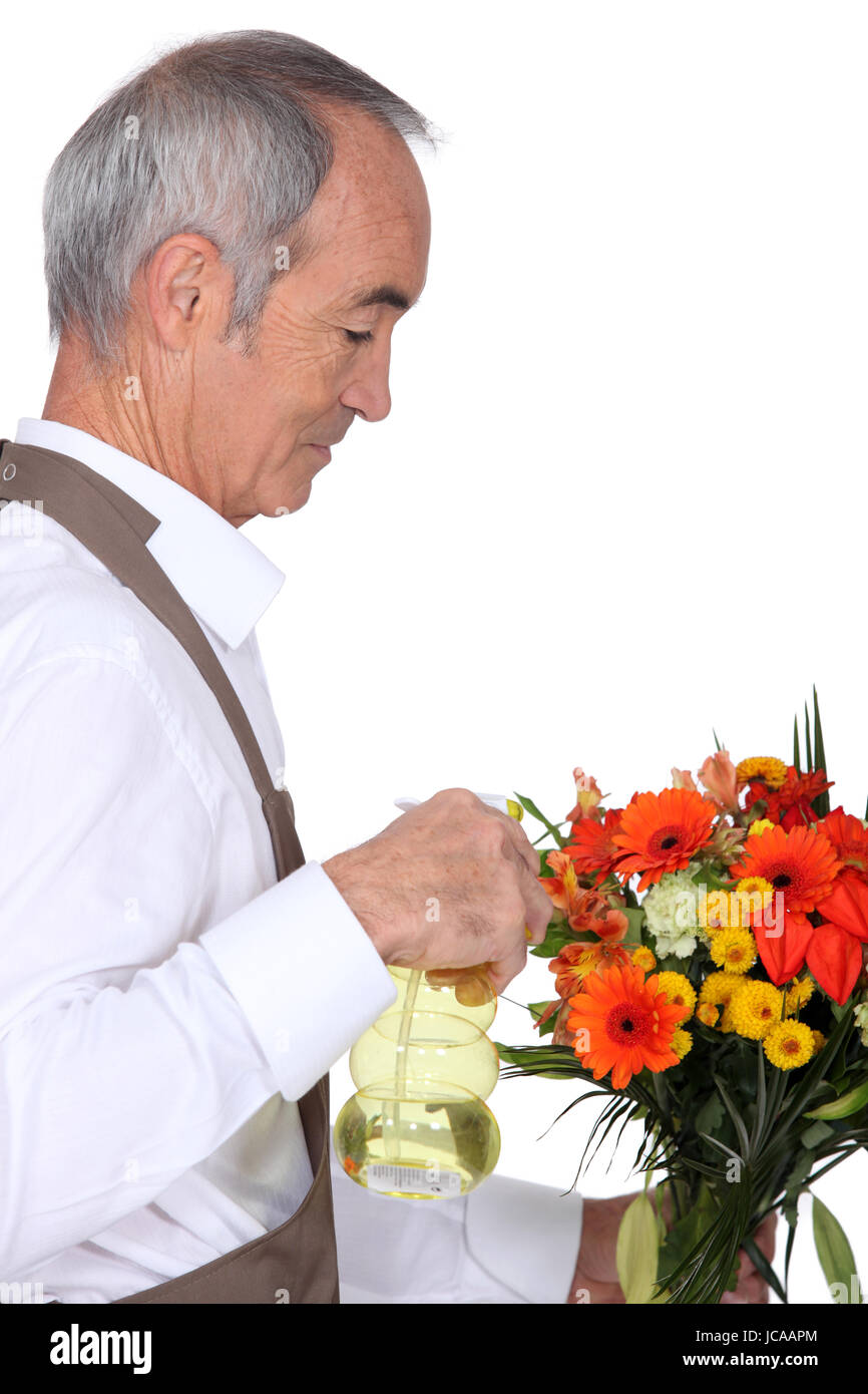 Man spraying flowers Stock Photo - Alamy
