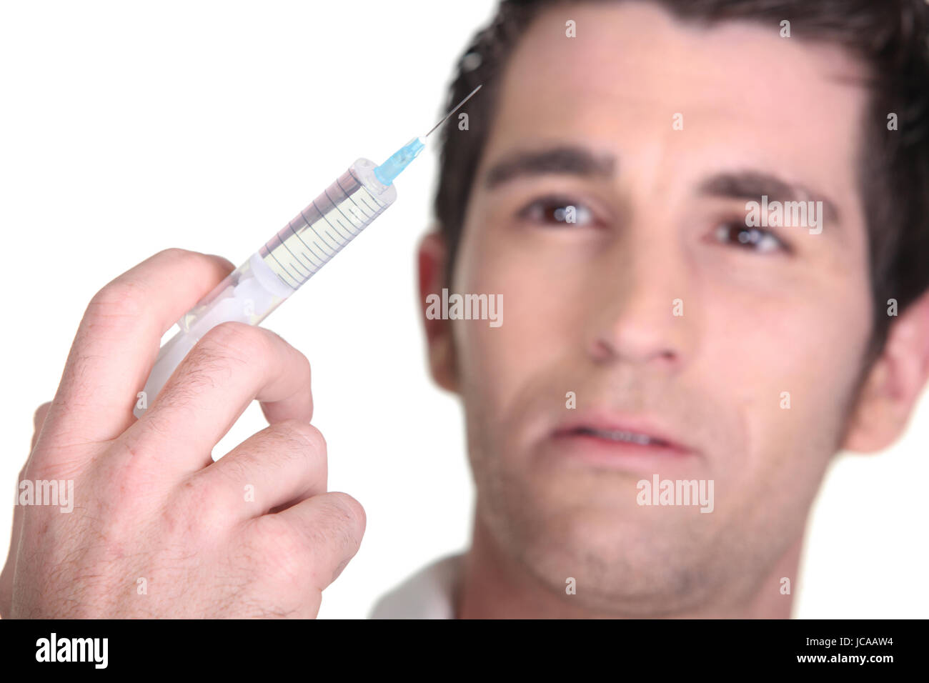 Man with syringe in hand Stock Photo - Alamy