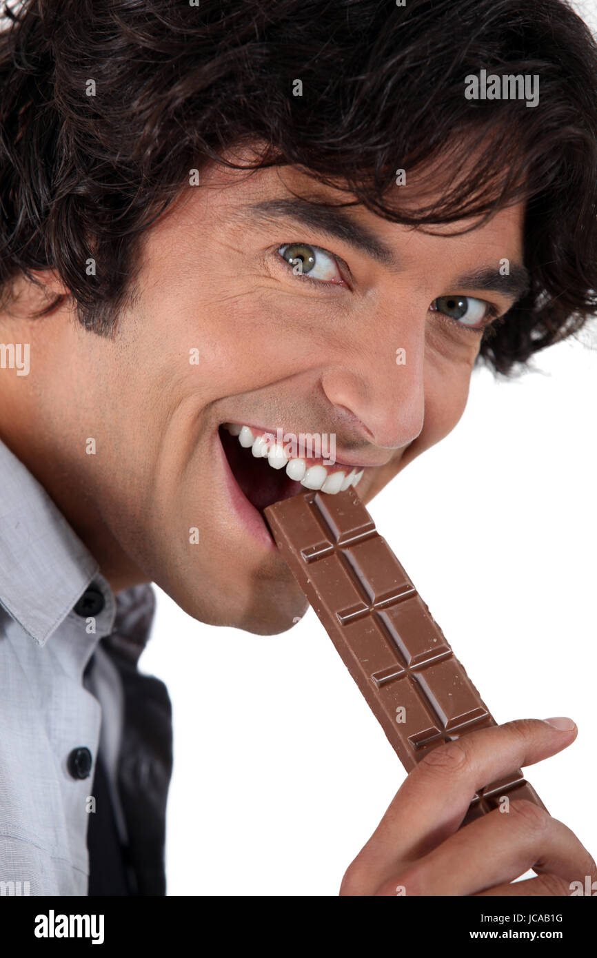 Man with a bar of chocolate Stock Photo - Alamy
