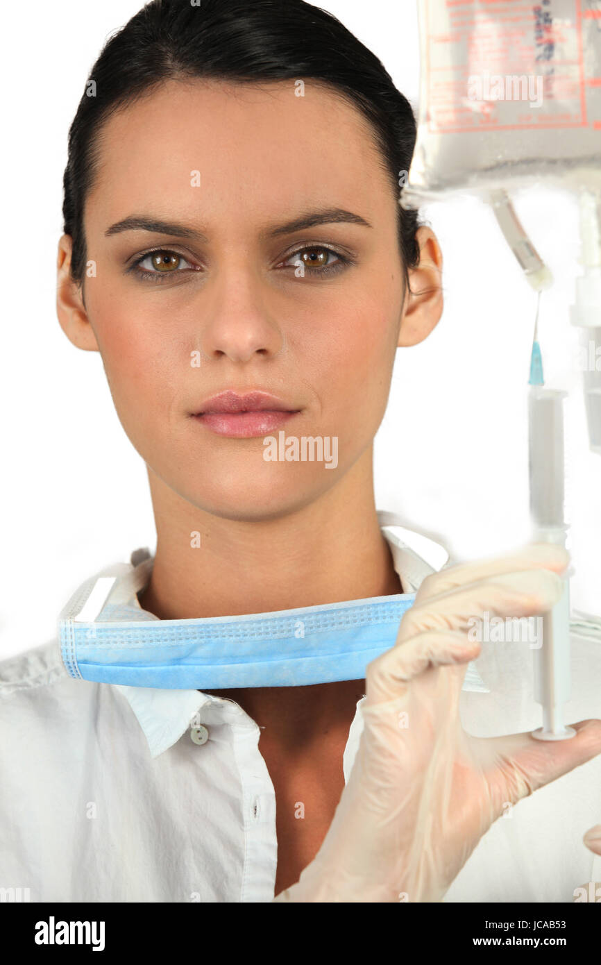 Nurse with drip and syringe Stock Photo - Alamy