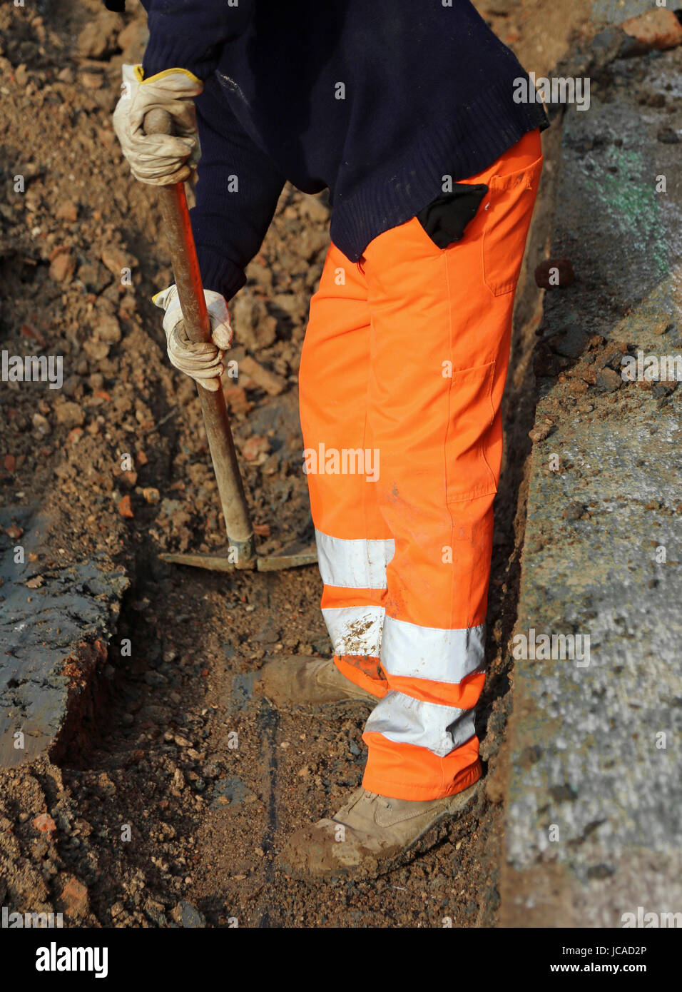 Worker with high visibility clothing while working on a road ...