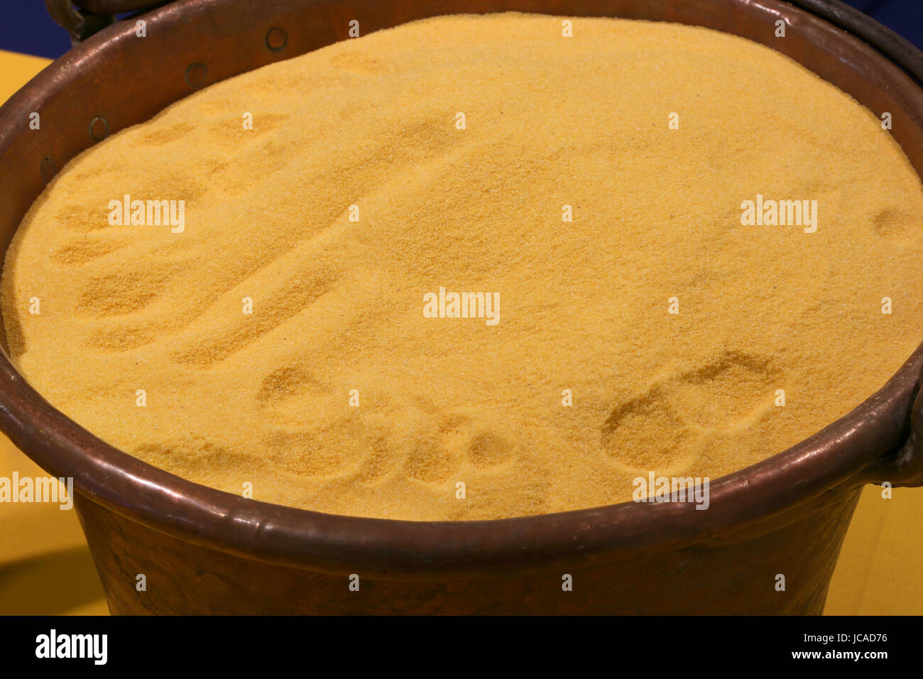 Yellow wheat flour in old copper cauldron Stock Photo - Alamy
